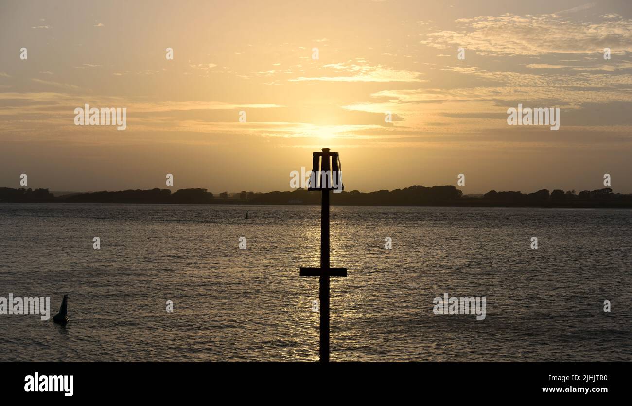 Orange skies over water at the end of a beautiful summer's day in ...