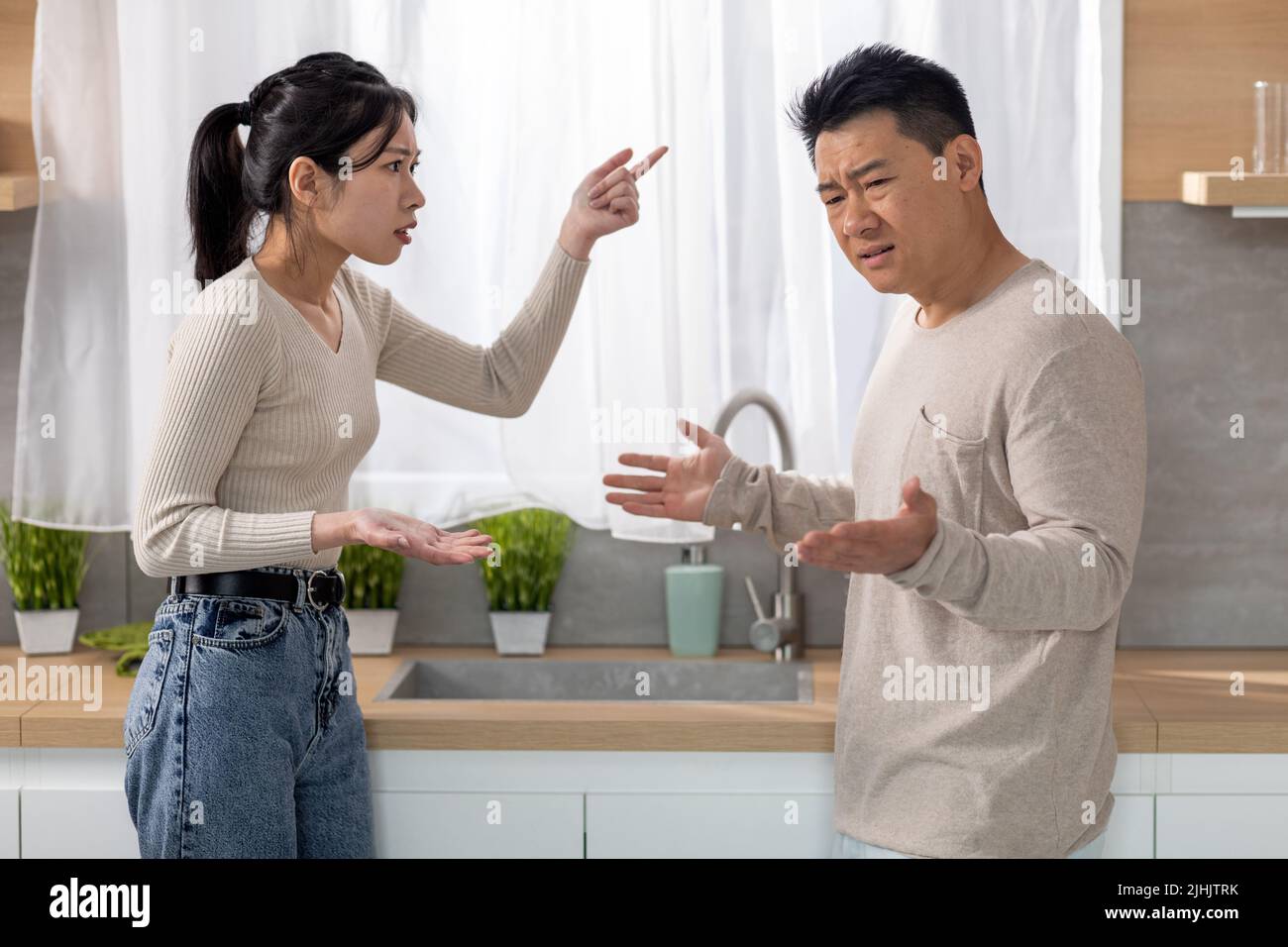 Emotional chinese spouses having fight at kitchen Stock Photo - Alamy
