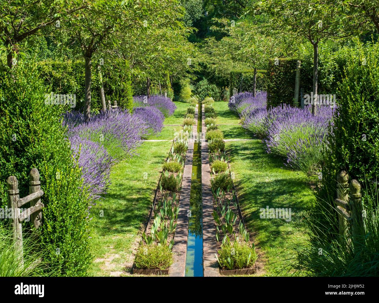 Landscaped garden with lavender and flowing water at Jardin Domaine de ...