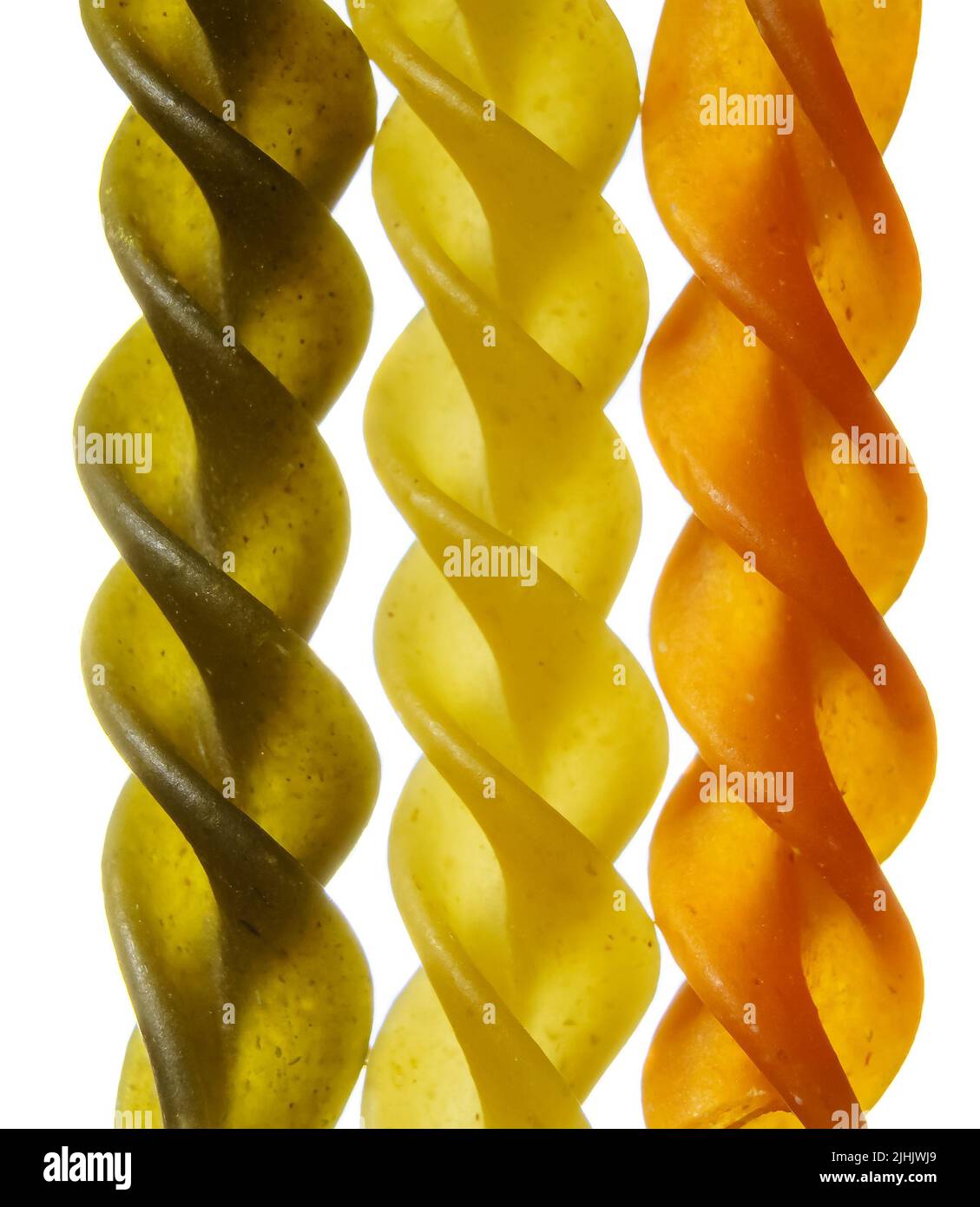 Uncooked raw tricolor macaroni pasta on white background. Macro food ...