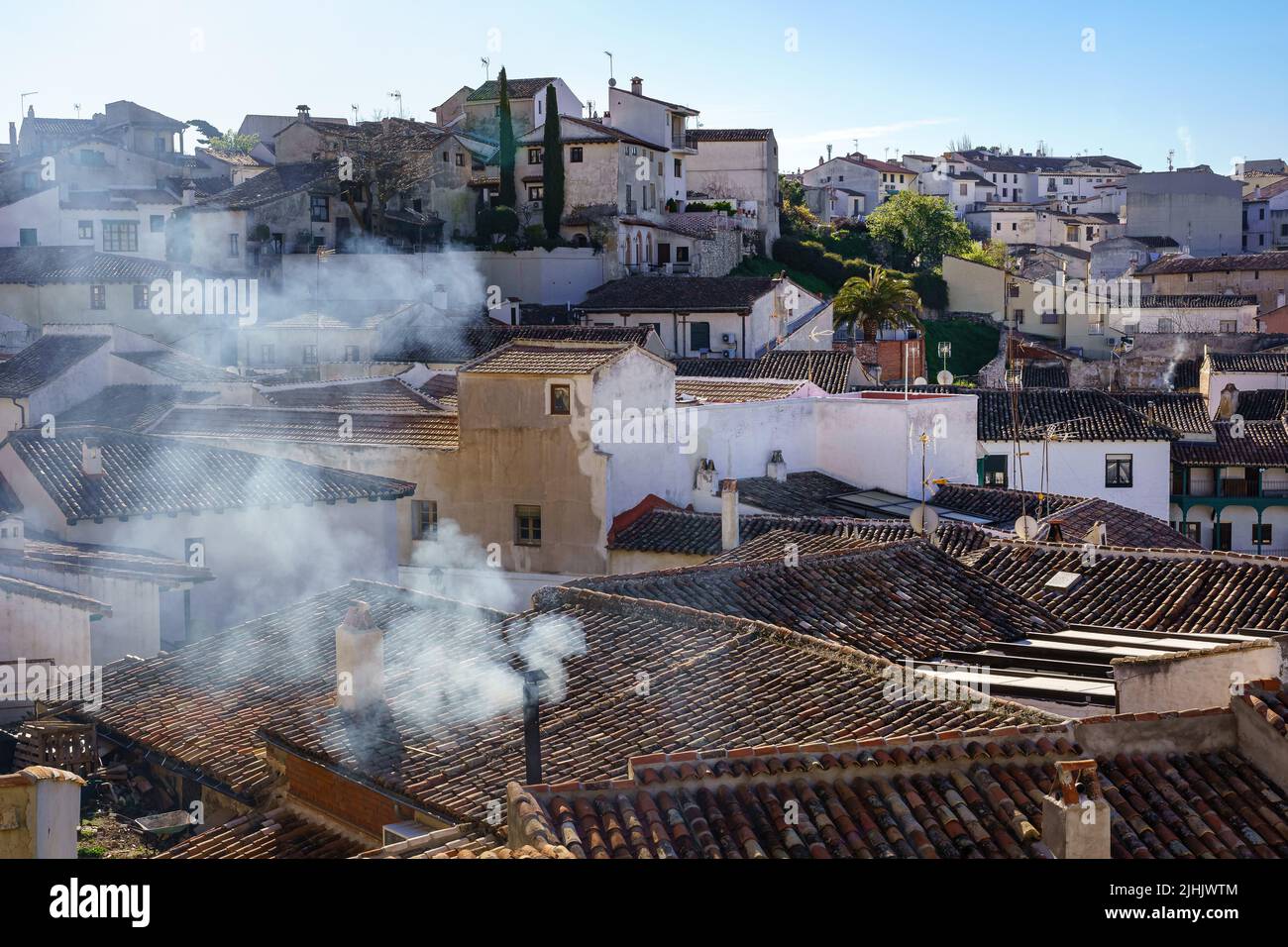 Aerial view of an old town in Spain with smokestacks at sunrise ...