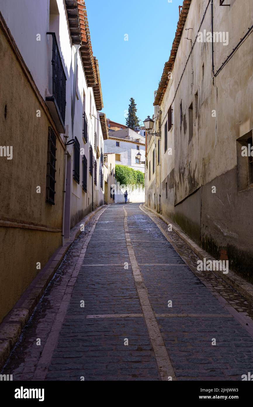 Narrow alley with old stone houses in a medieval village in Spain ...