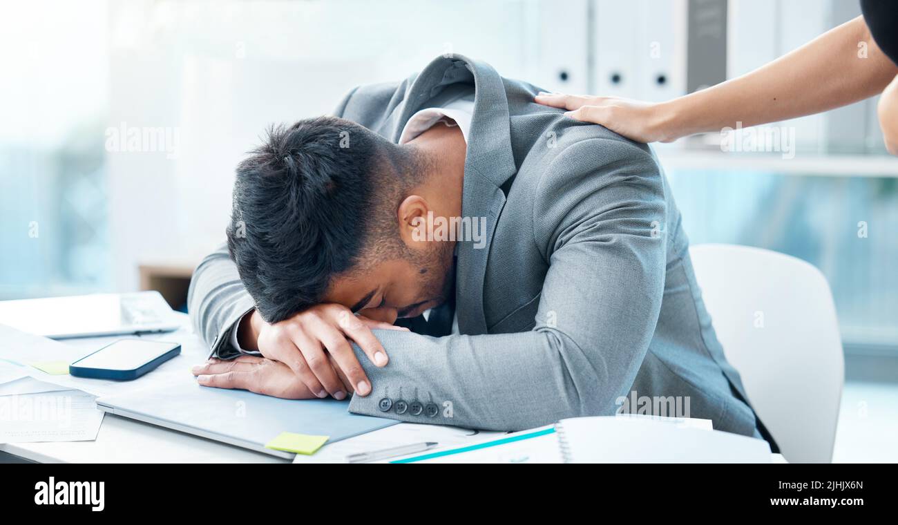 Excuse me, please wake up.... a young businessman sleeping at his desk ...