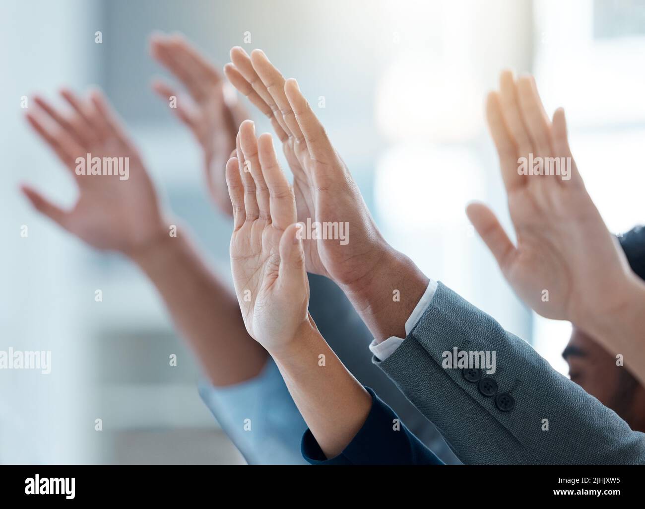 Hungry for knowledge. a group of business people with their hands ...
