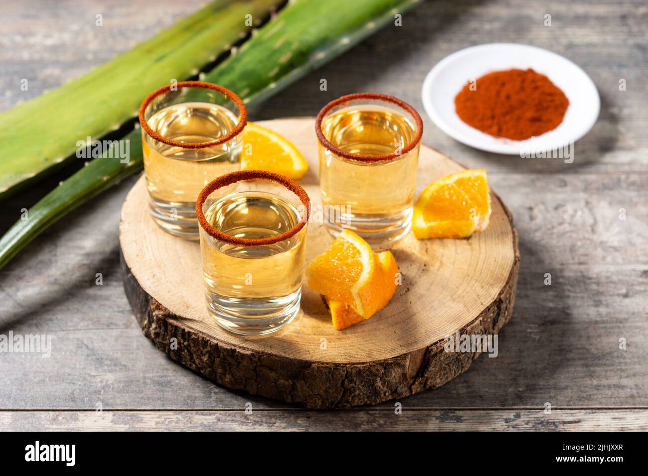 Mezcal Mexican drink with orange slices and worm salt on wooden table ...