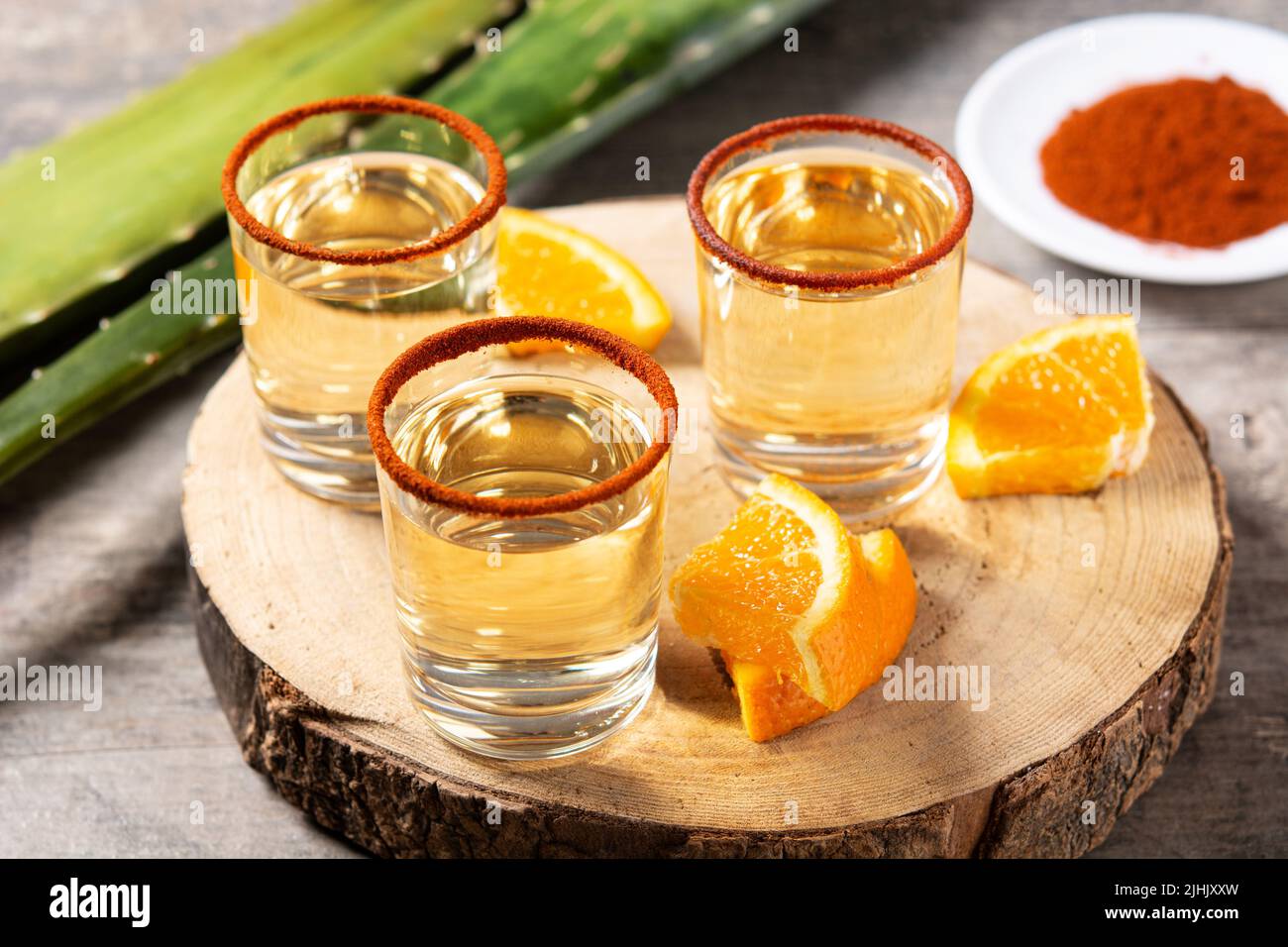 Mezcal Mexican drink with orange slices and worm salt on wooden table ...