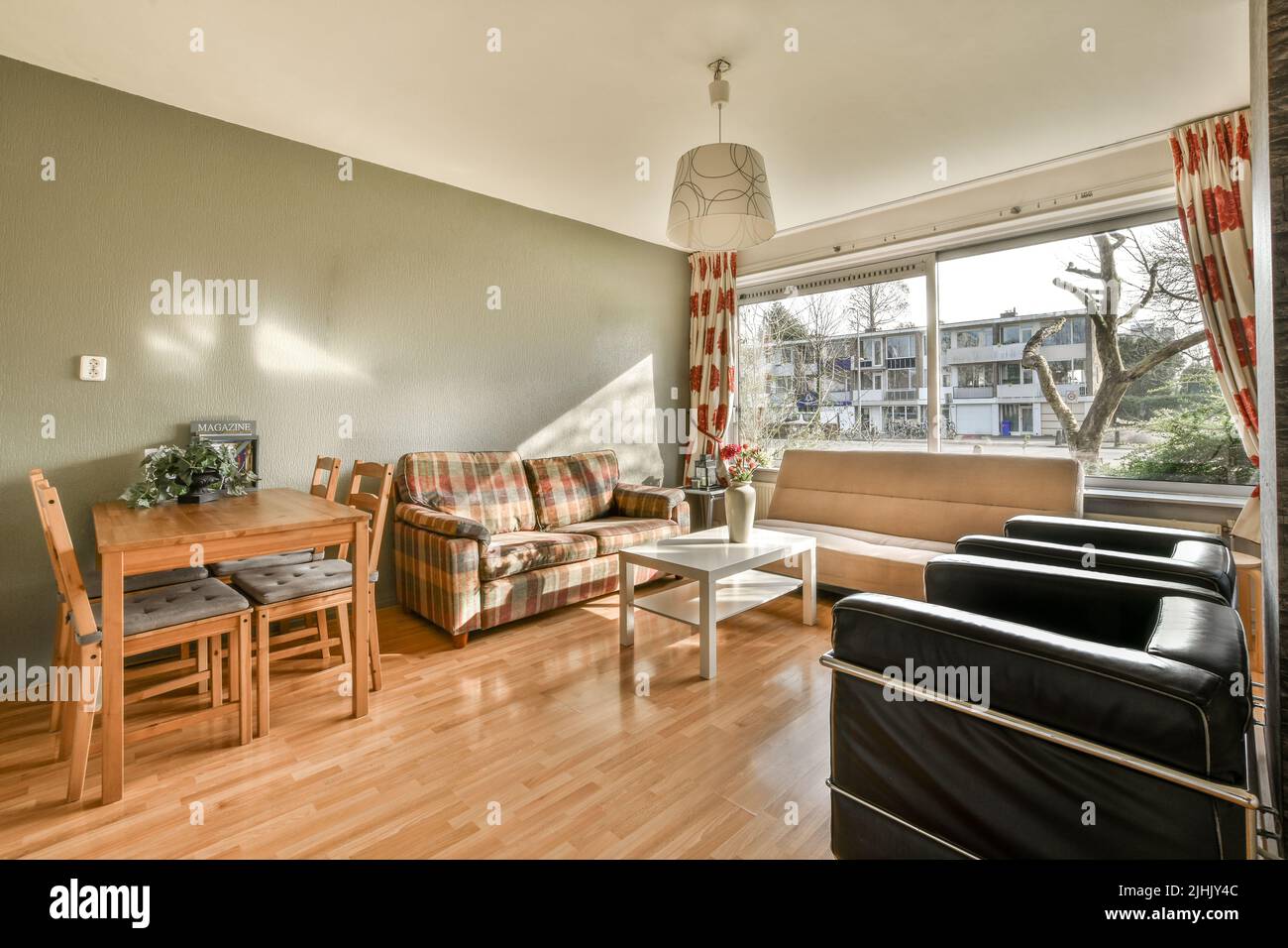 Simple expensive interior of living room with sofa near big window ...