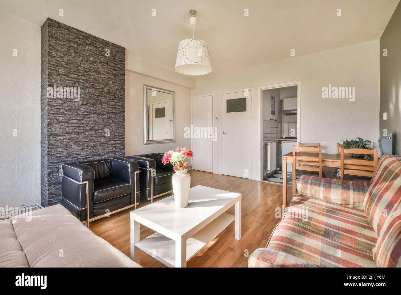 Simple expensive interior of living room with sofa near big window ...