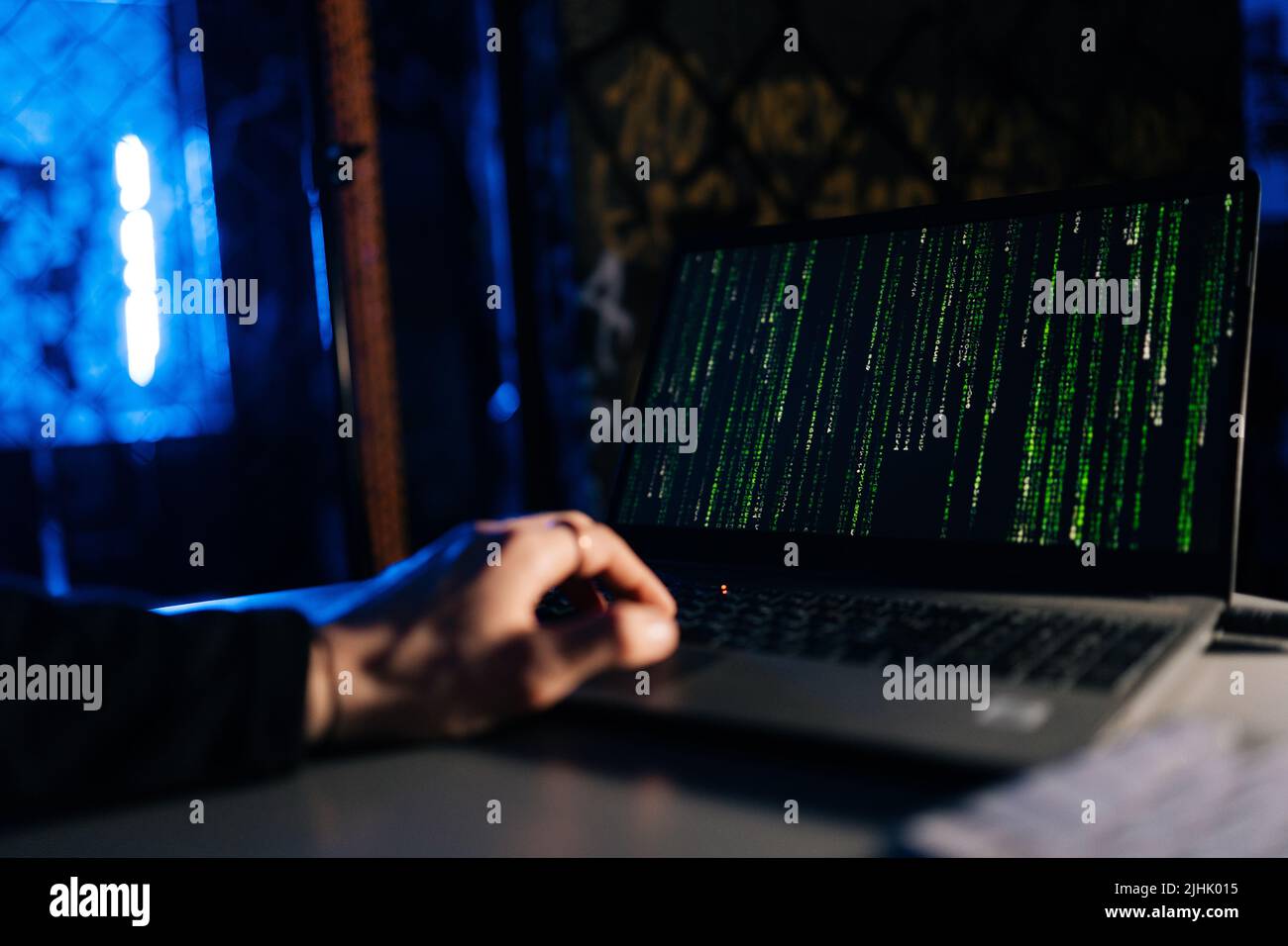 Close Up Of Unrecognizable Hacker Engaged In Hacking Into Security System On Laptop Green Binary