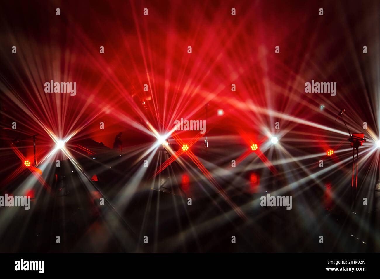 Multi-colored spotlights illuminate the stage before the concert. The ...