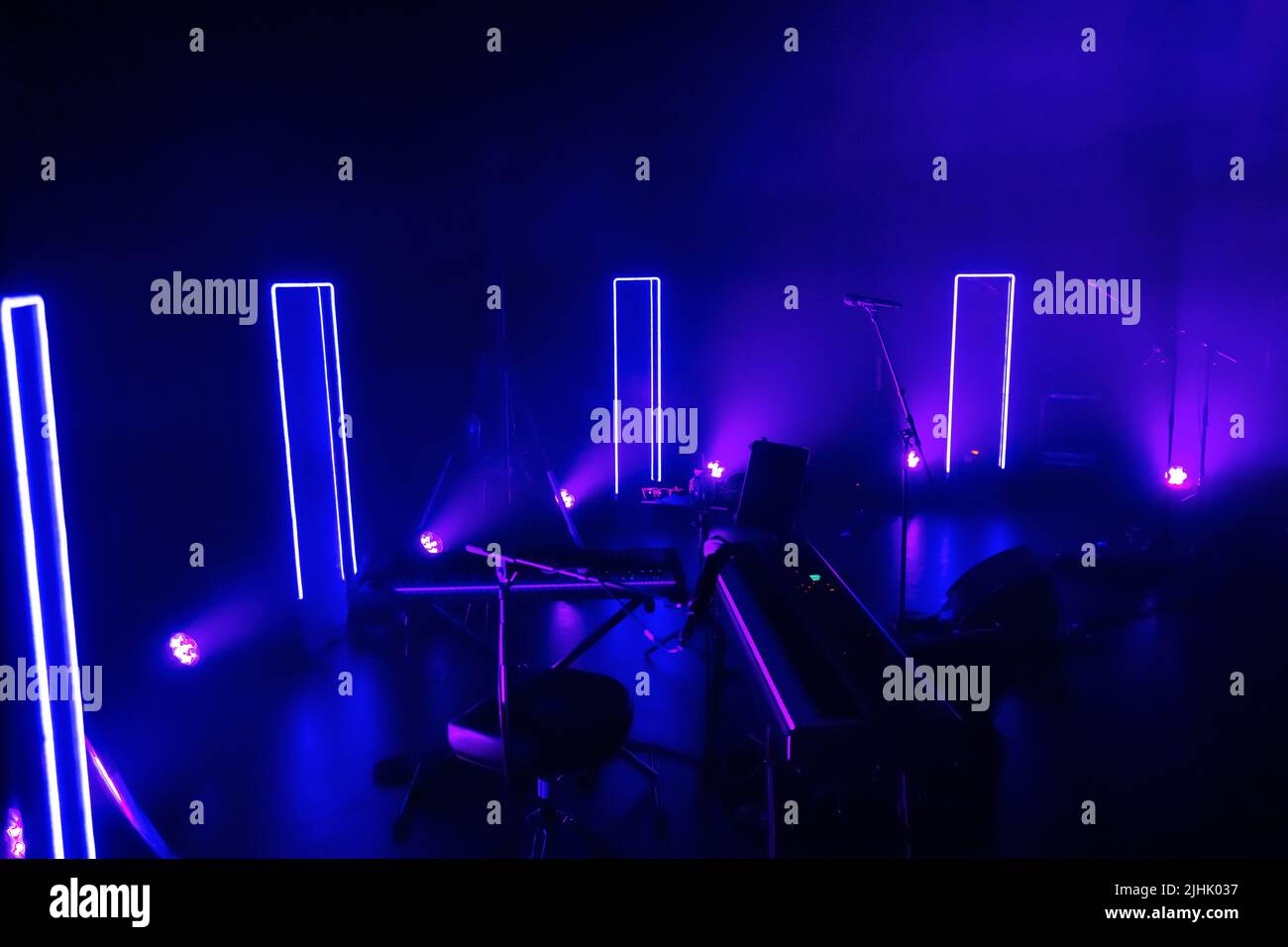 Multi-colored spotlights illuminate the stage before the concert. The ...