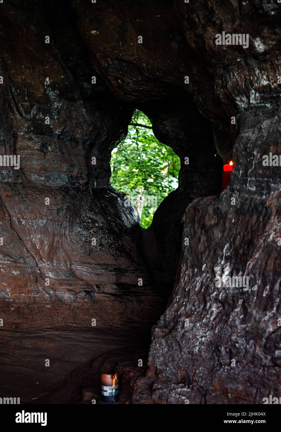 A candle burns near the exit of the witches' cave on Mount Saint-Michel ...