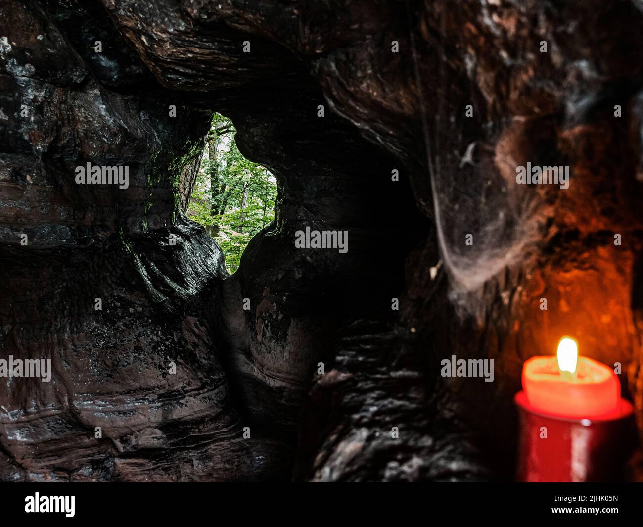A candle burns near the exit of the witches' cave on Mount Saint-Michel ...
