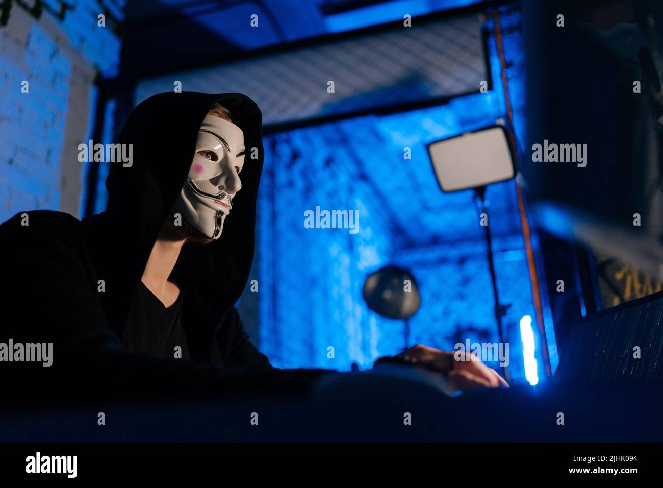 Close-up low-angle view of unrecognizable hooded hacker man wearing ...