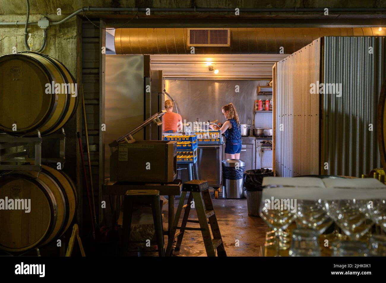Staff washing wine glasses in the cellar kitchen at Norman Hardie ...