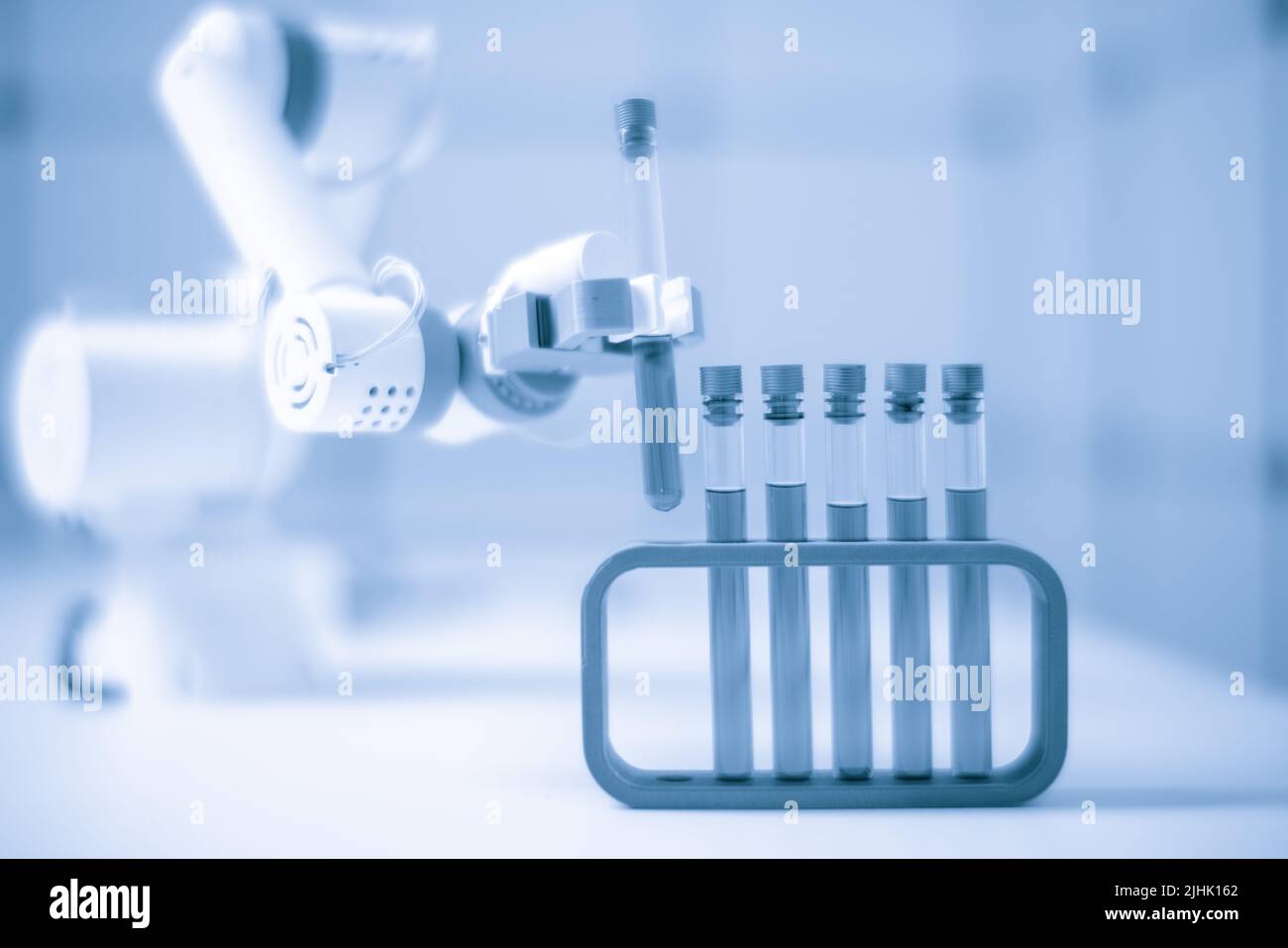 Robot take a test tube with a liquid from Test tube rack in a ...