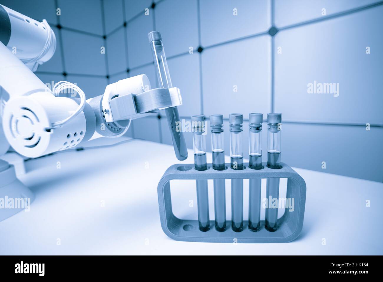 Robot take a test tube with a liquid from Test tube rack in a ...