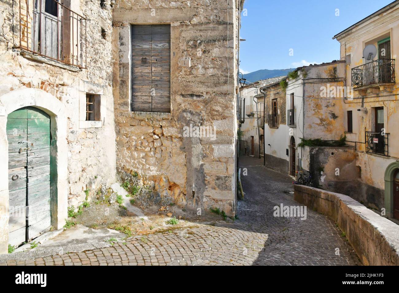 A narrow street between the old stone houses of Cansano, a medieval village in the Abruzzo ...