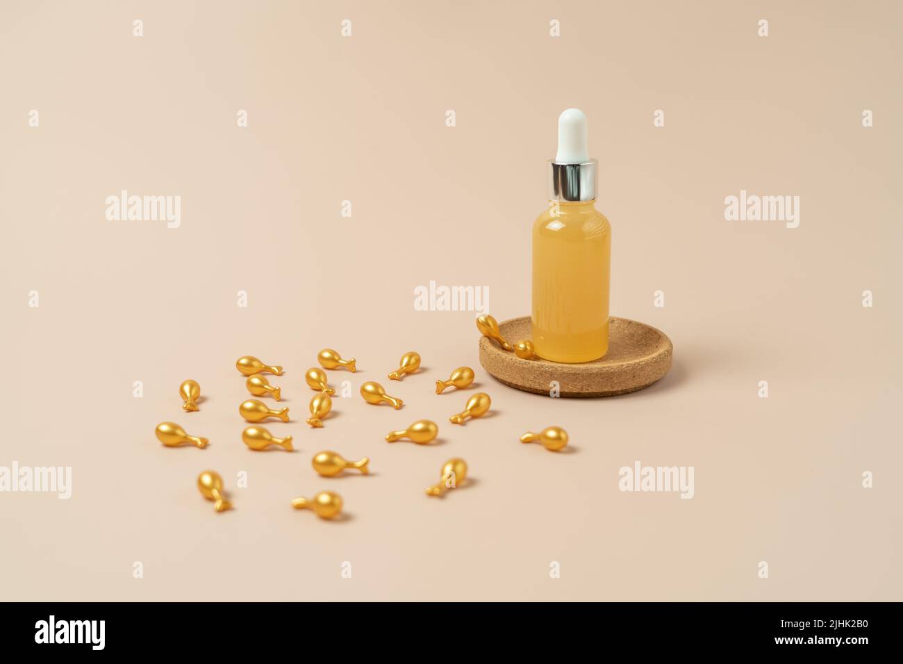Golden capsules face serum hi-res stock photography and images - Alamy