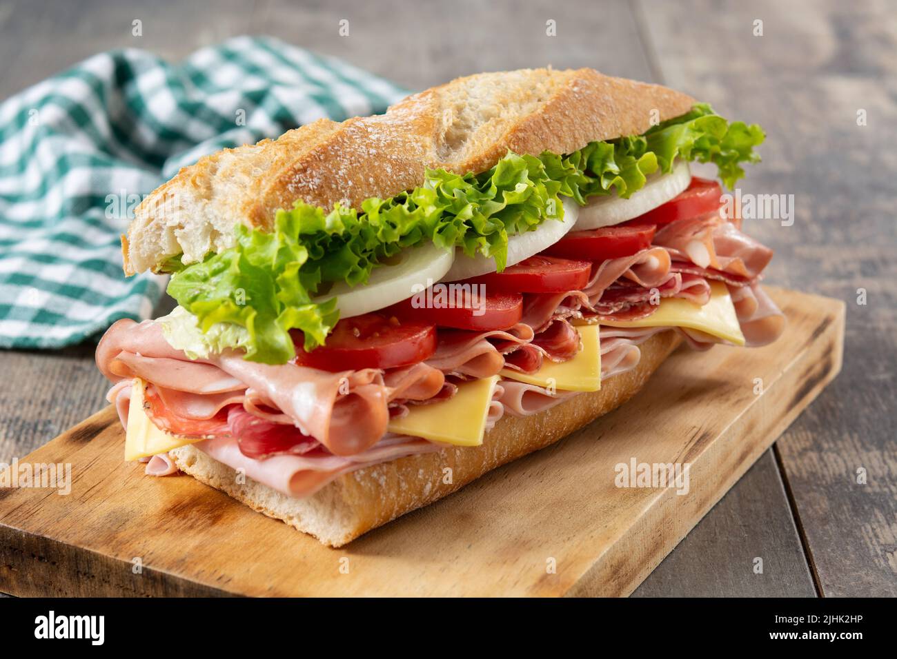 Submarine sandwich with ham, cheese, lettuce, tomatoes,onion ...
