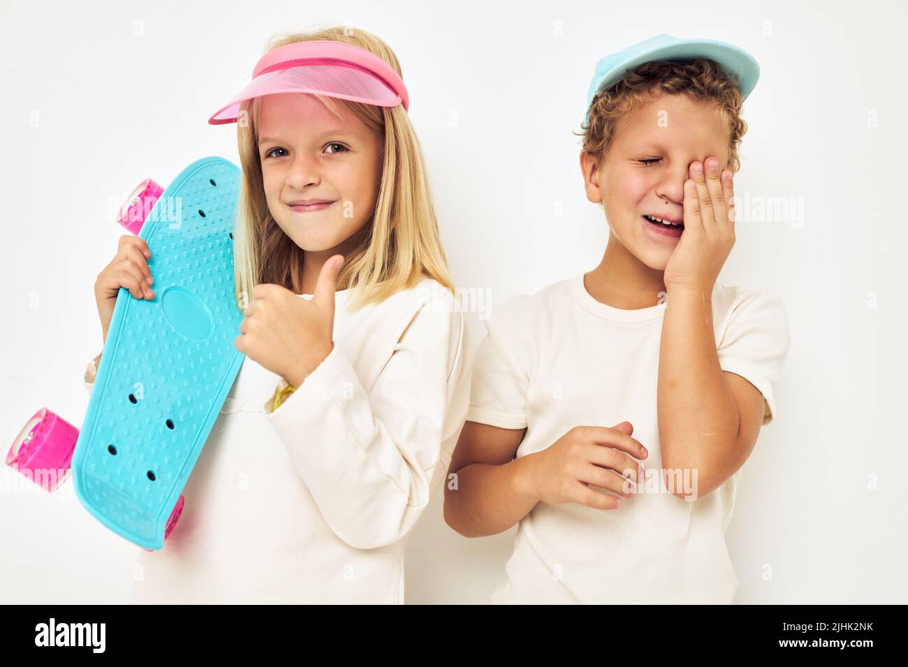 Portrait of two young smiling kids posing games fun light background ...