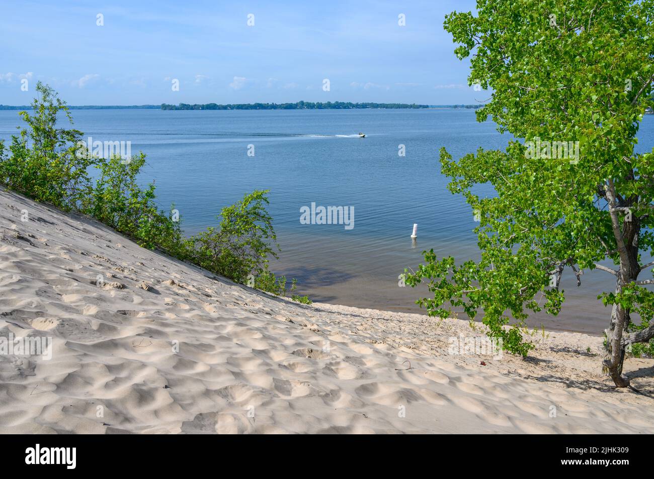 View across West Lake, with a water scooter speeding on the water, from ...
