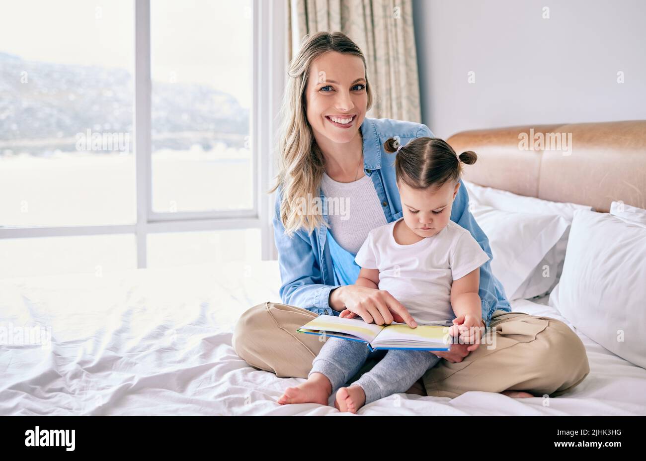 Books keep curious little minds busy. a woman reading to her adorable ...