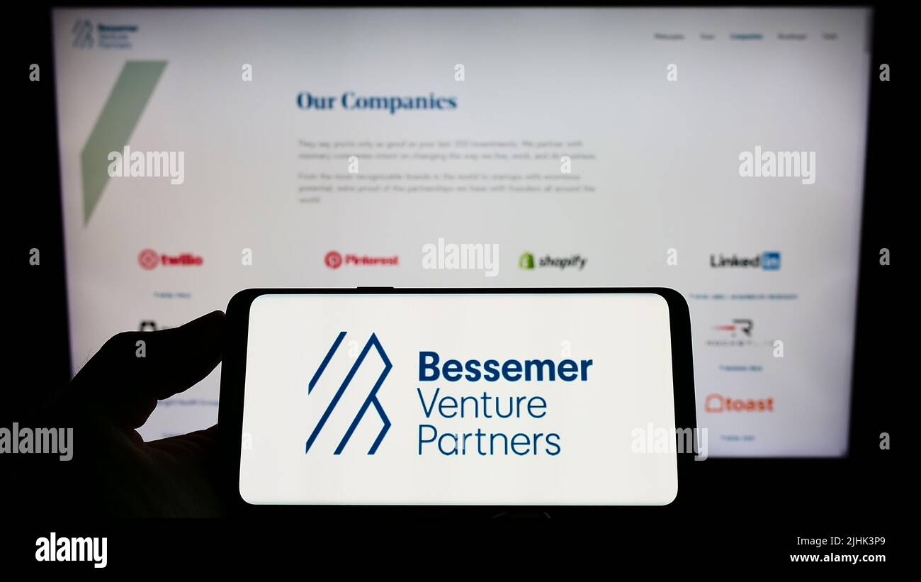 Person holding cellphone with logo of US company Bessemer Venture Partners (BVP) on screen in ...
