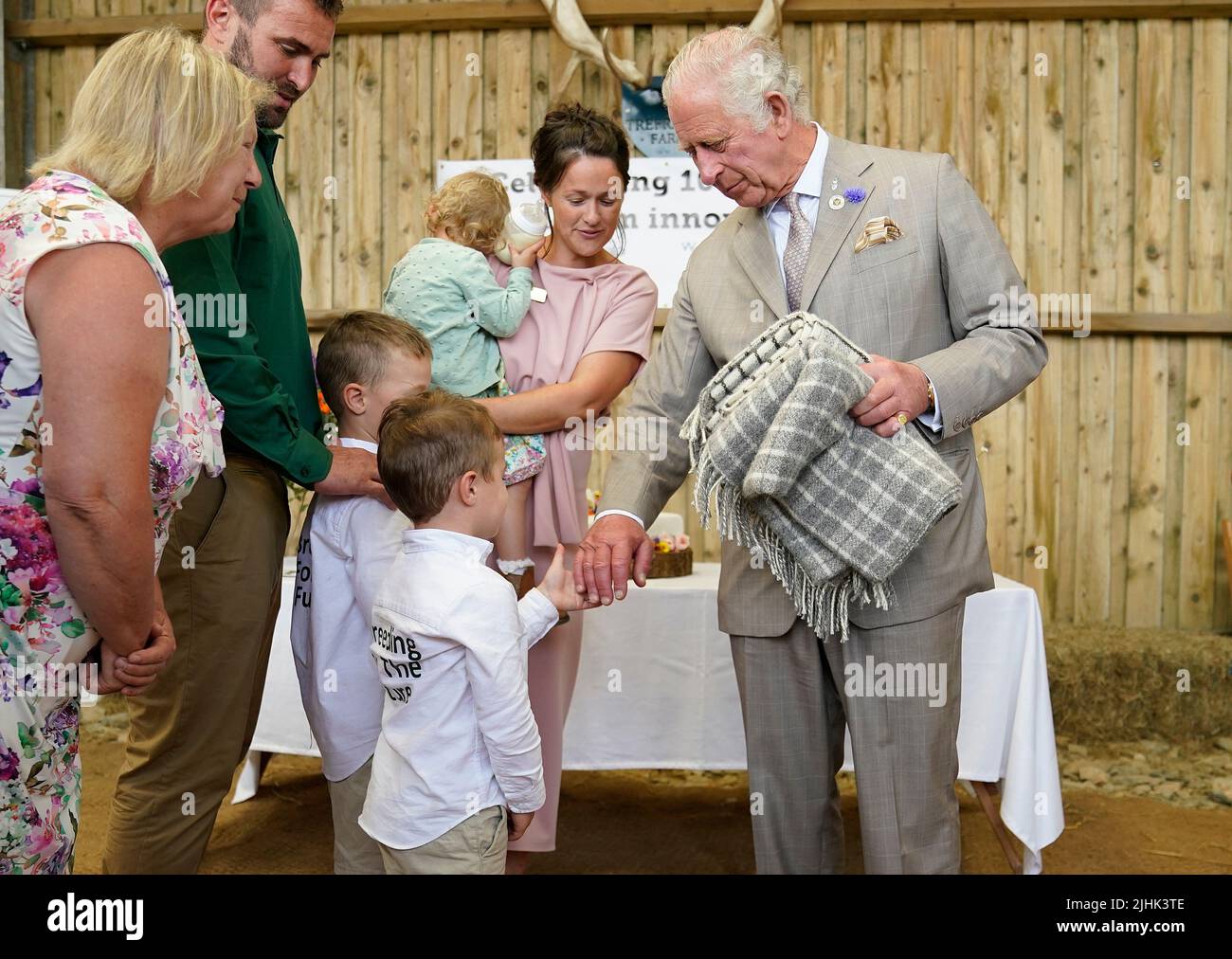 The Duke of Cornwall shakes the hand of George Smith, son of Matt and ...