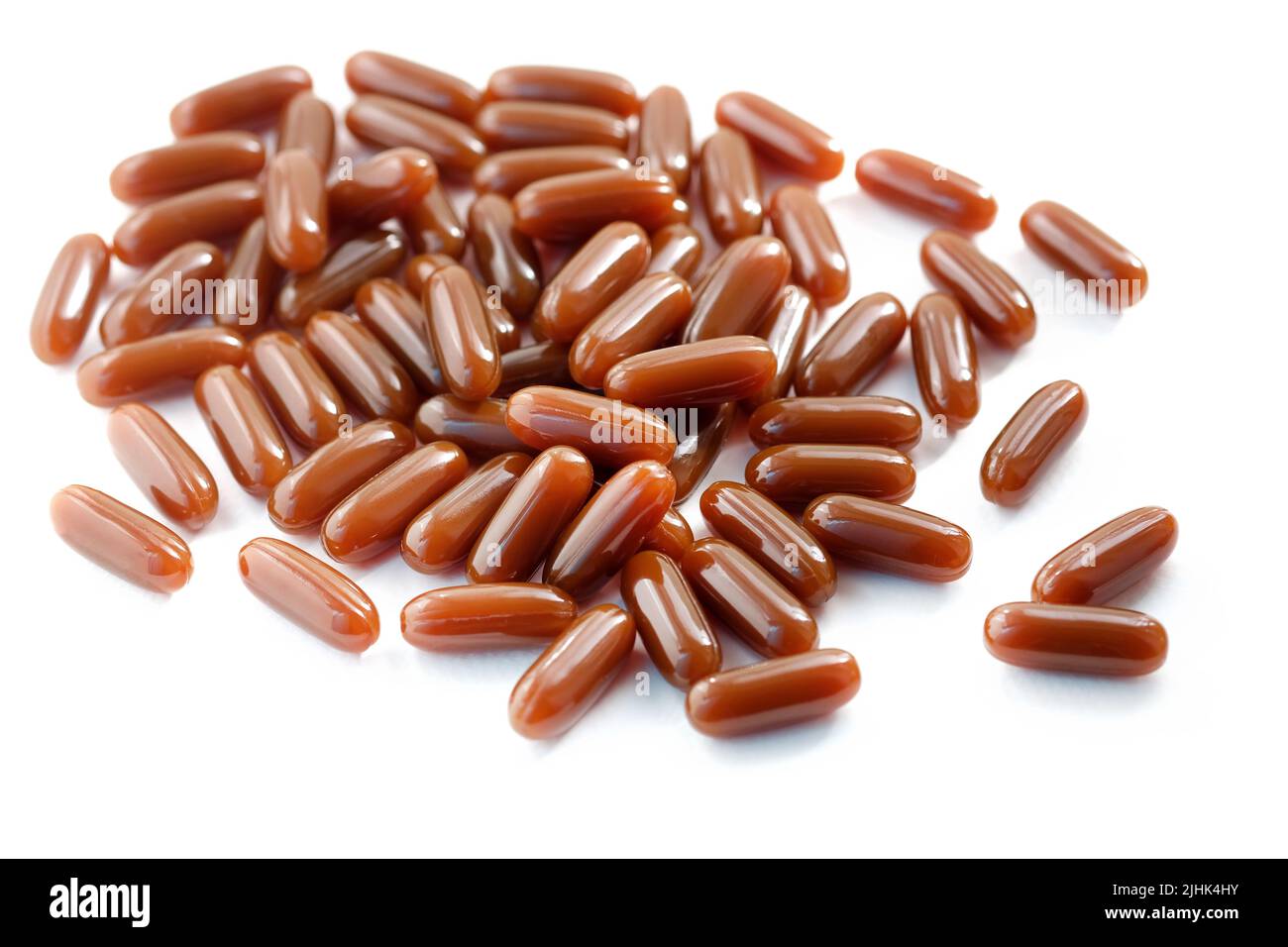 Sunflower lecithin in capsules on a white background. Lecithin in brown ...