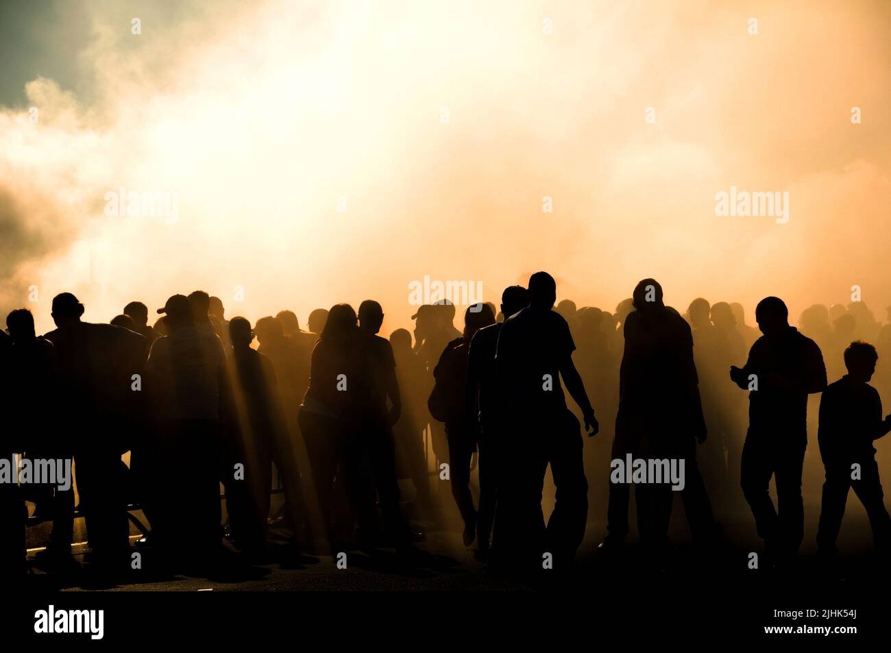 Silhouette of group of people surrounded by heavy smoke from burnt ...