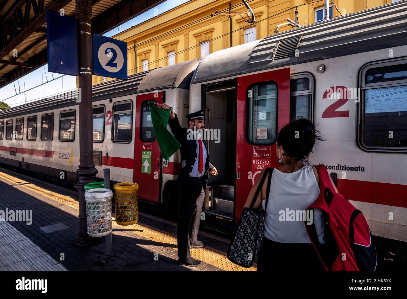 The train's ticket inspector waves a green flag to warn tourists and ...
