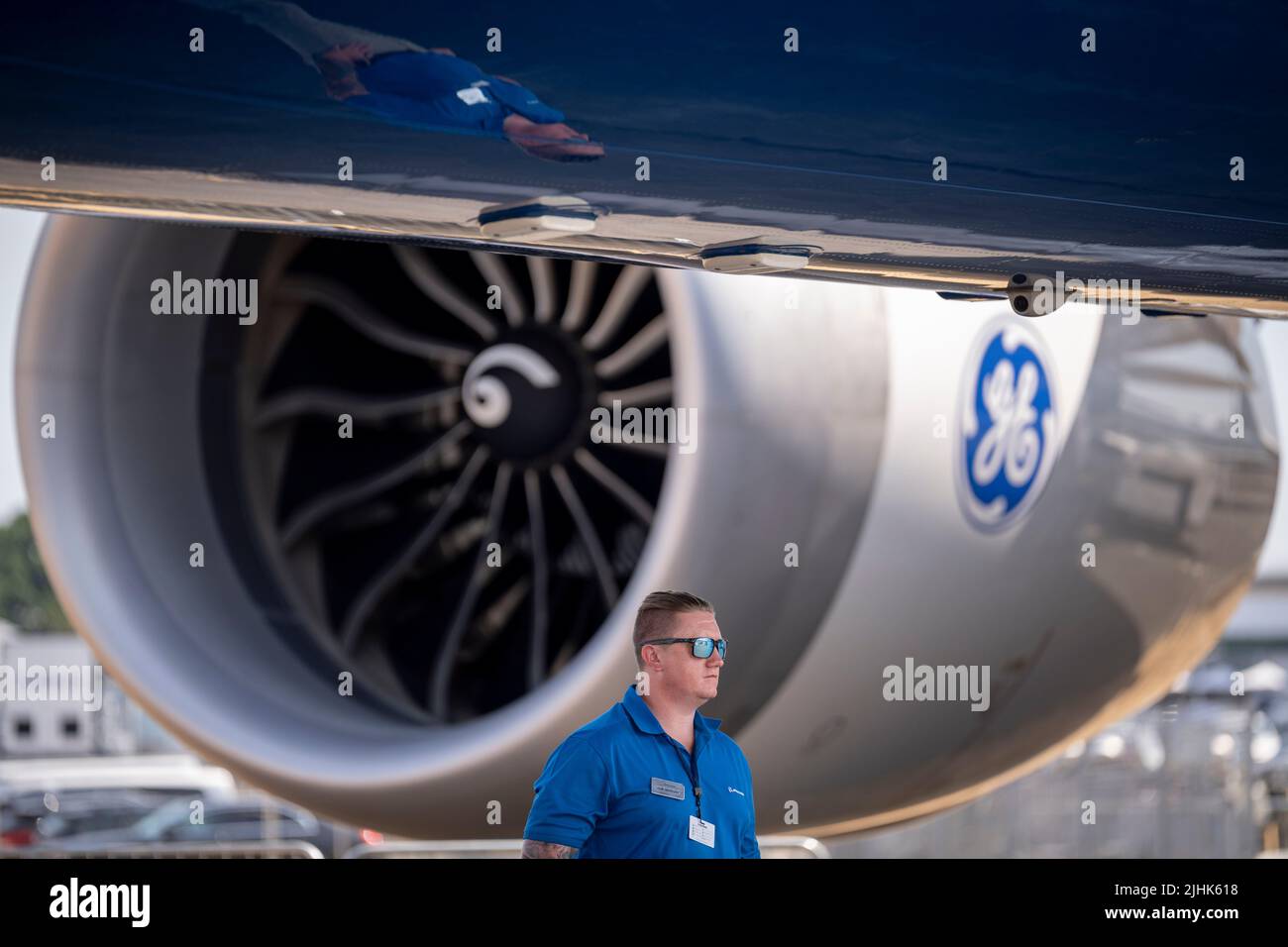 A Boeing employee stands beneath the fuselage of the company's 777X jet ...