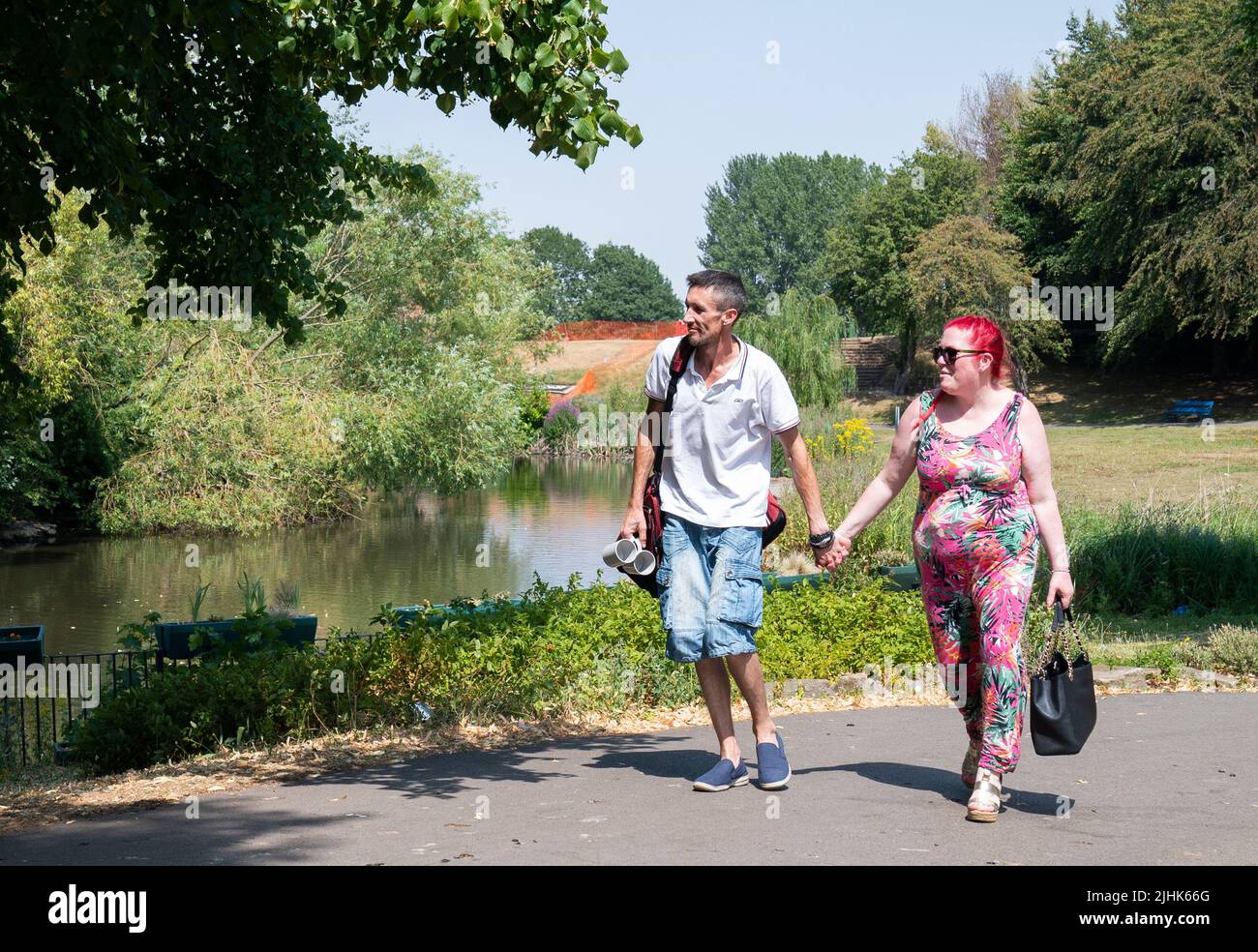People walk in Sandall Park, Doncaster, as temperatures have reached ...