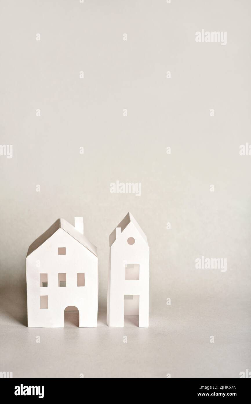 paper houses on light grey background. real estate and development ...