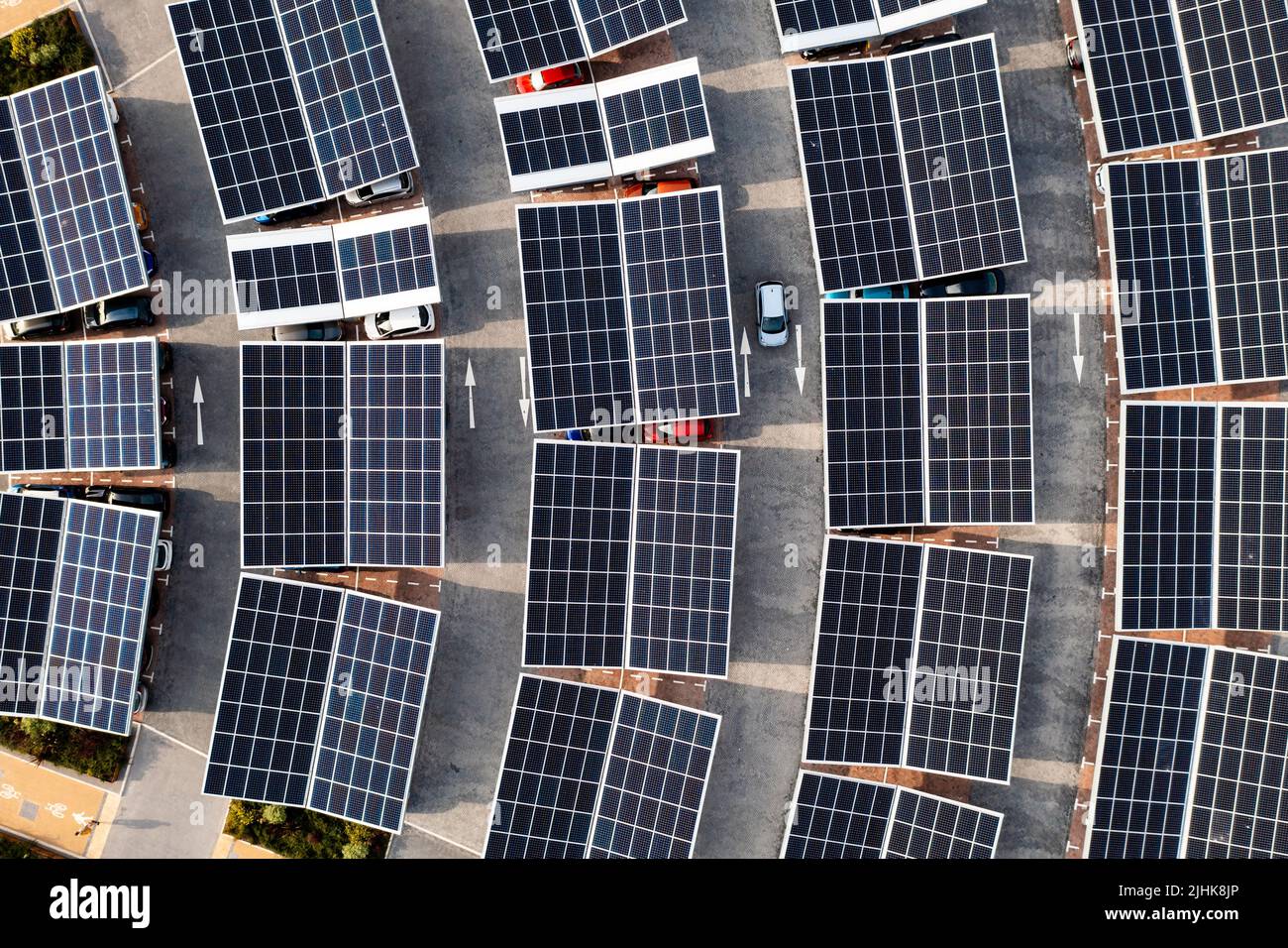 Aerial view directly above electric cars parking under solar panels on ...