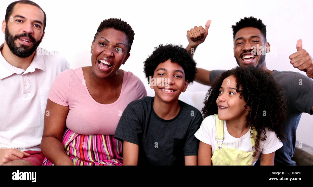 Family waving hello to camera speaking video conference POV Stock Photo ...
