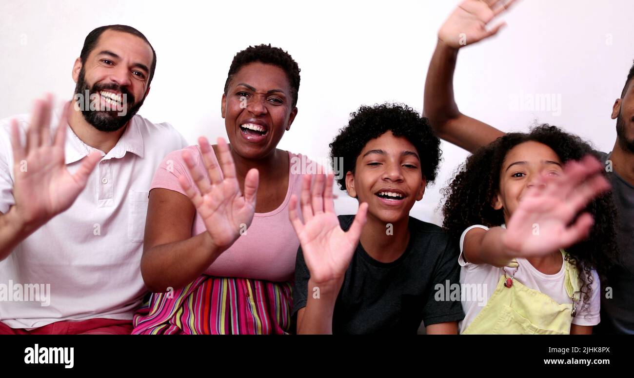 Family waving hello to camera speaking video conference POV Stock Photo ...