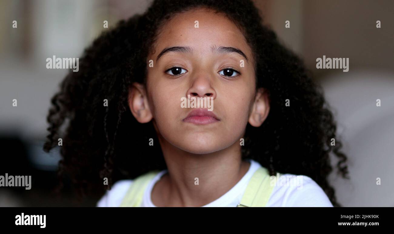 Female mixed race child girl staring camera. Serious little kid Stock ...