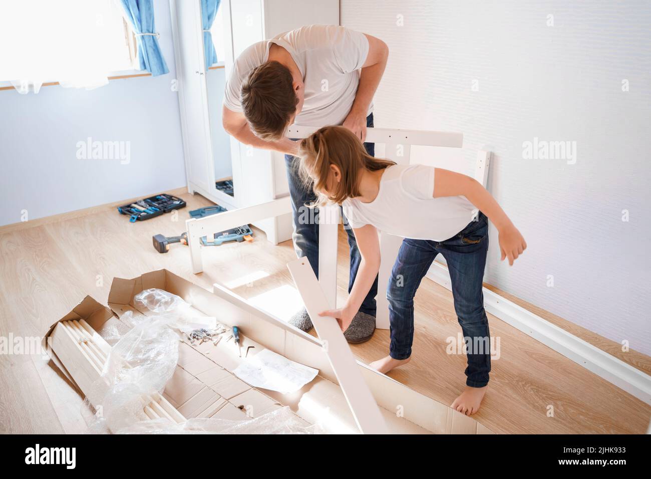 Dad,little girls daughters assemblle wooden baby bed according to ...