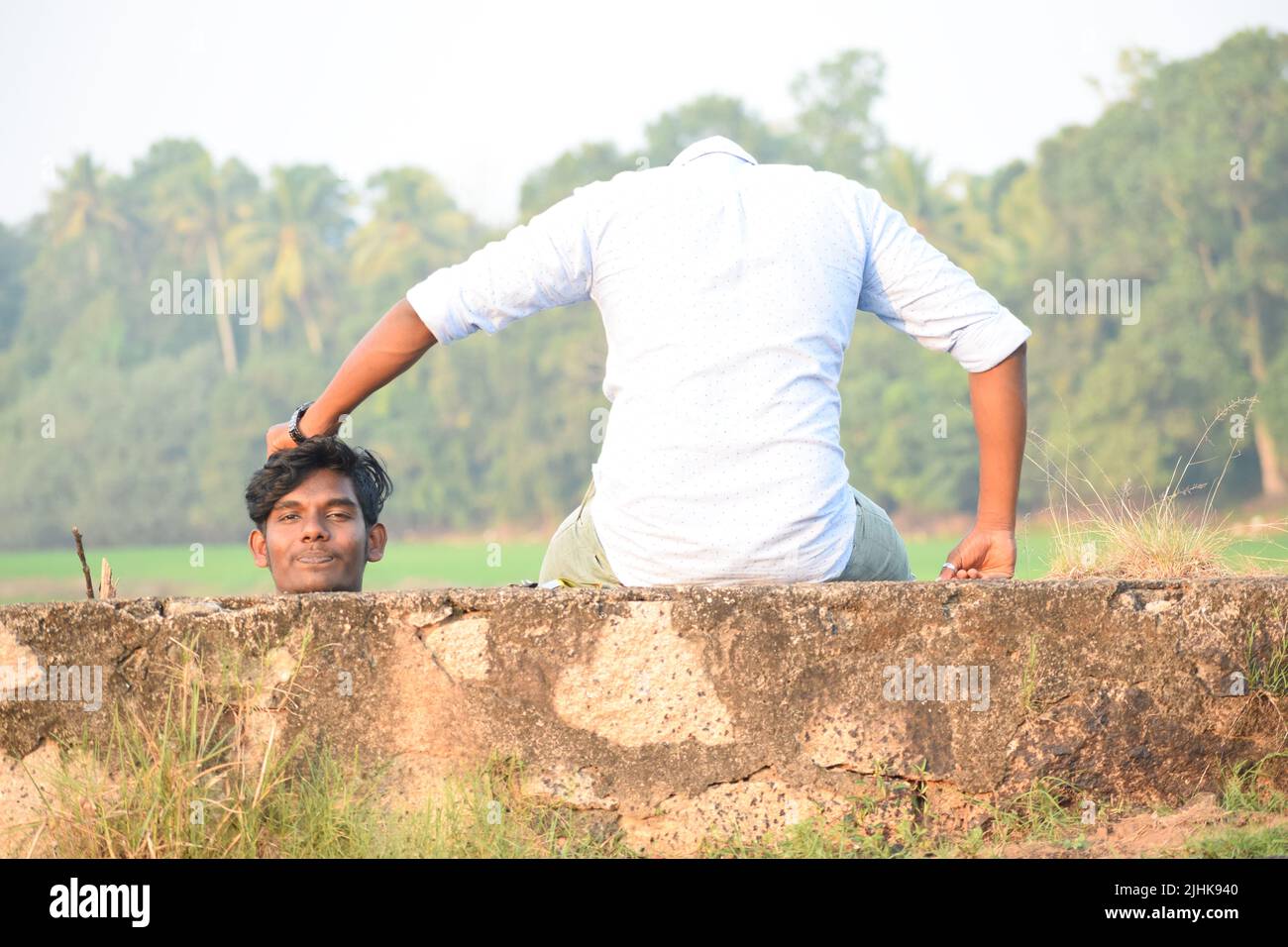 Two young men posing for photo in a creative way. Concept- creative ...
