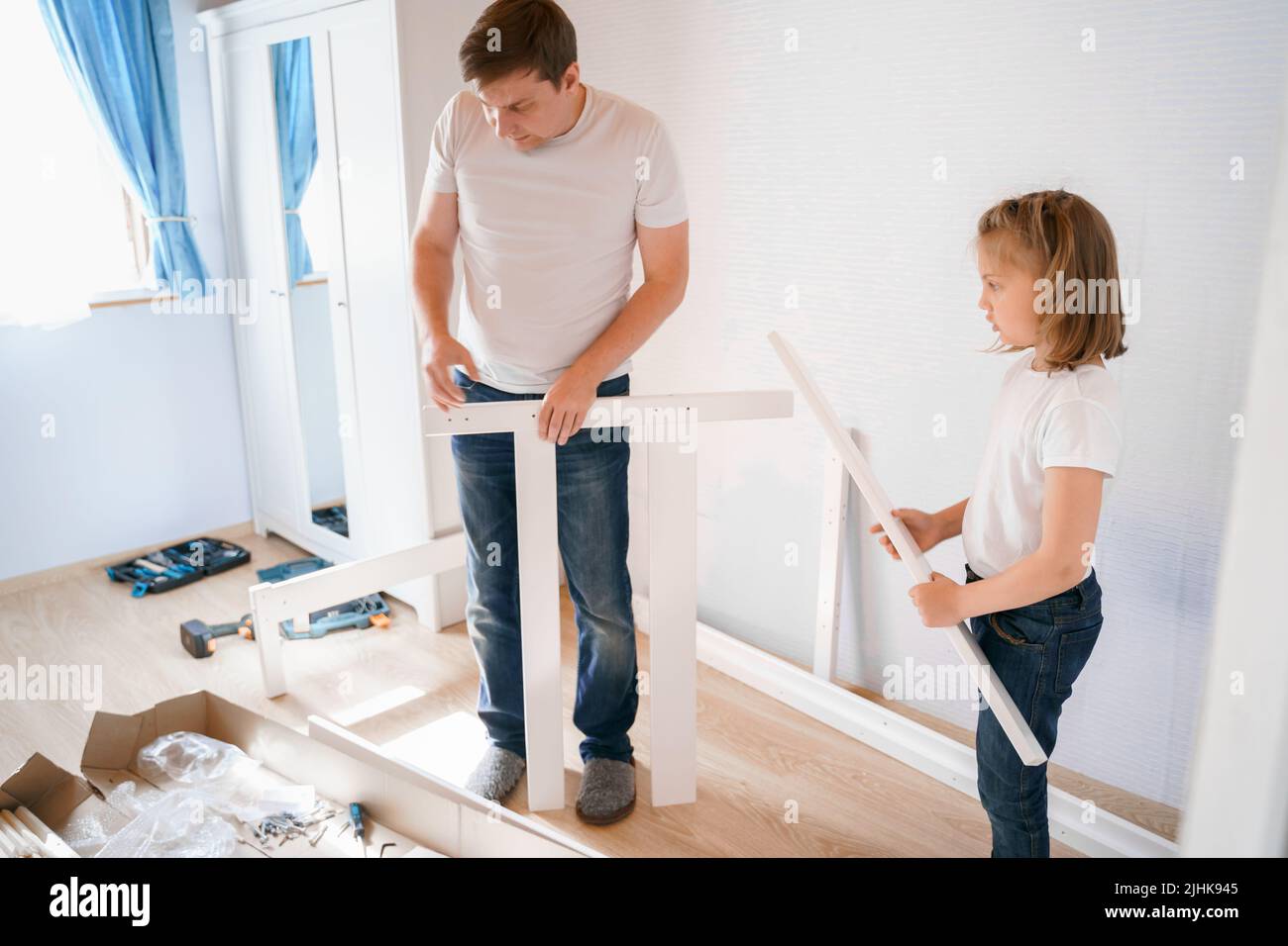 Dad,little girls daughters assemblle wooden baby bed according to ...
