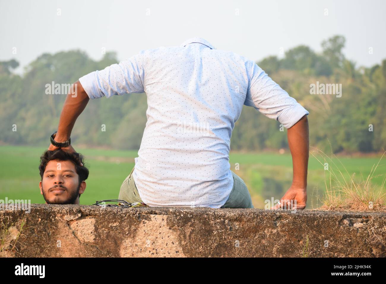 Two young men posing for photo in a creative way. Concept- creative ...