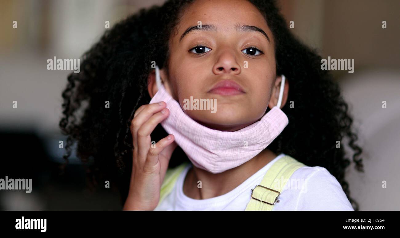 Girl removing covid face mask, little child takes off mask Stock Photo ...