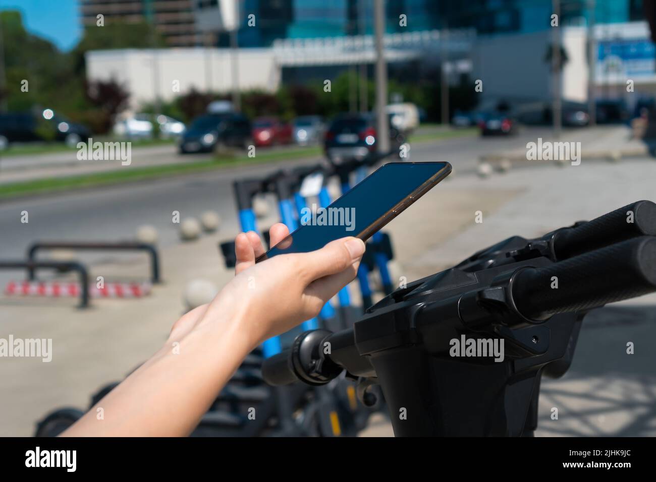 Close up woman's hand scans with a mobile phone the QR code of a ...