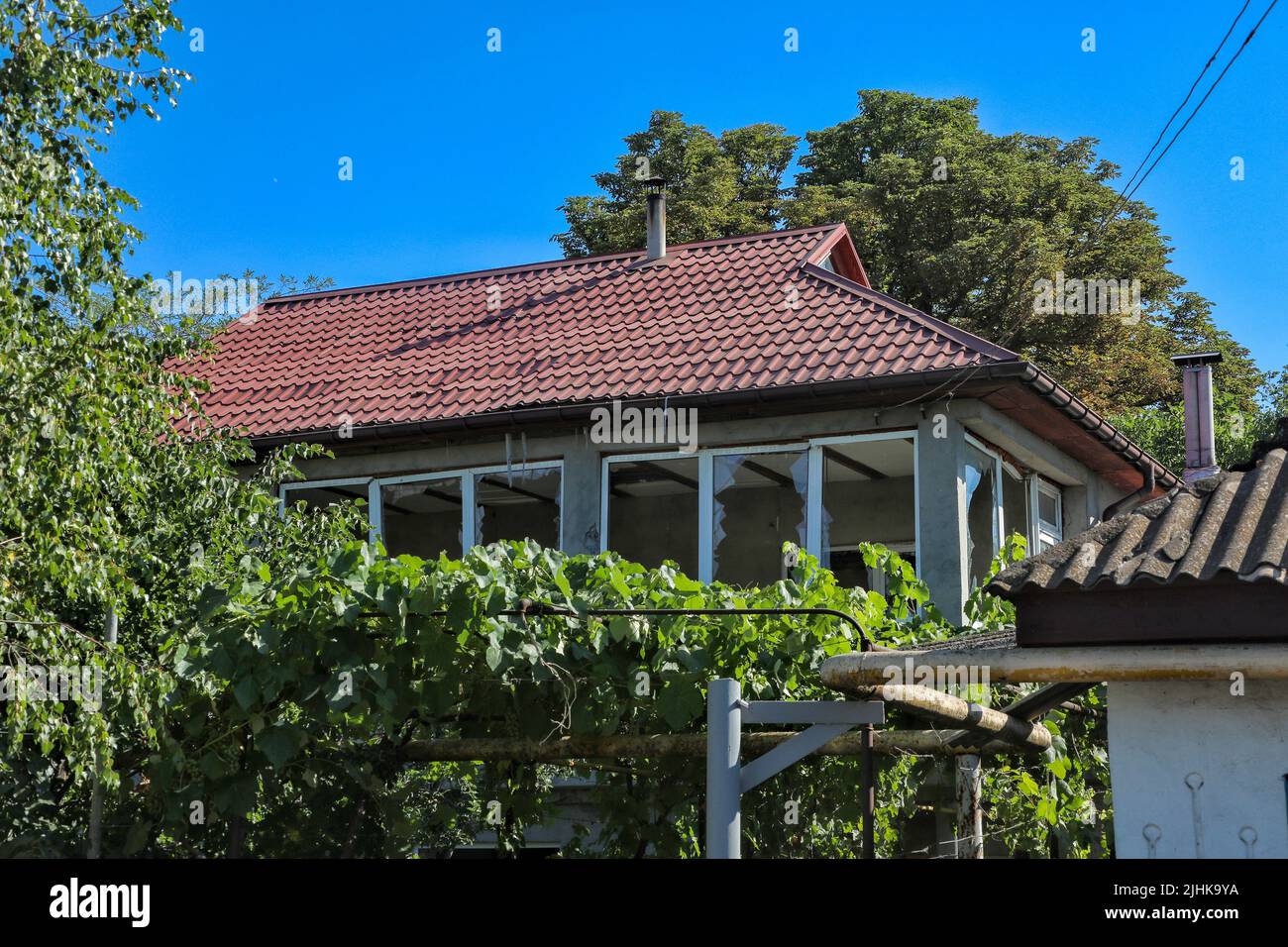 DACHNE, UKRAINE - JULY 19, 2022 - A house shows damage caused by a ...