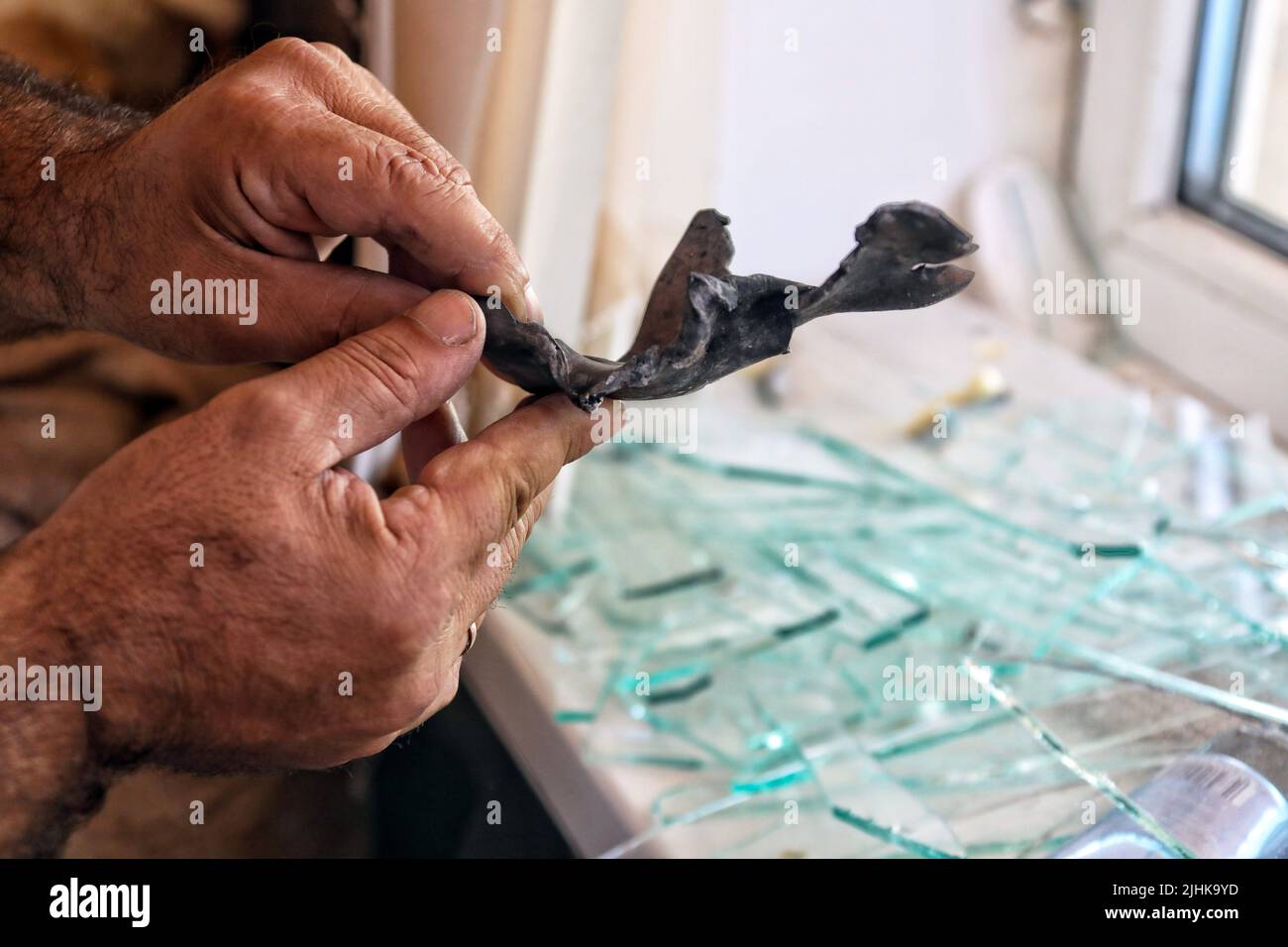 DACHNE, UKRAINE - JULY 19, 2022 - A person holds a fragment of a ...