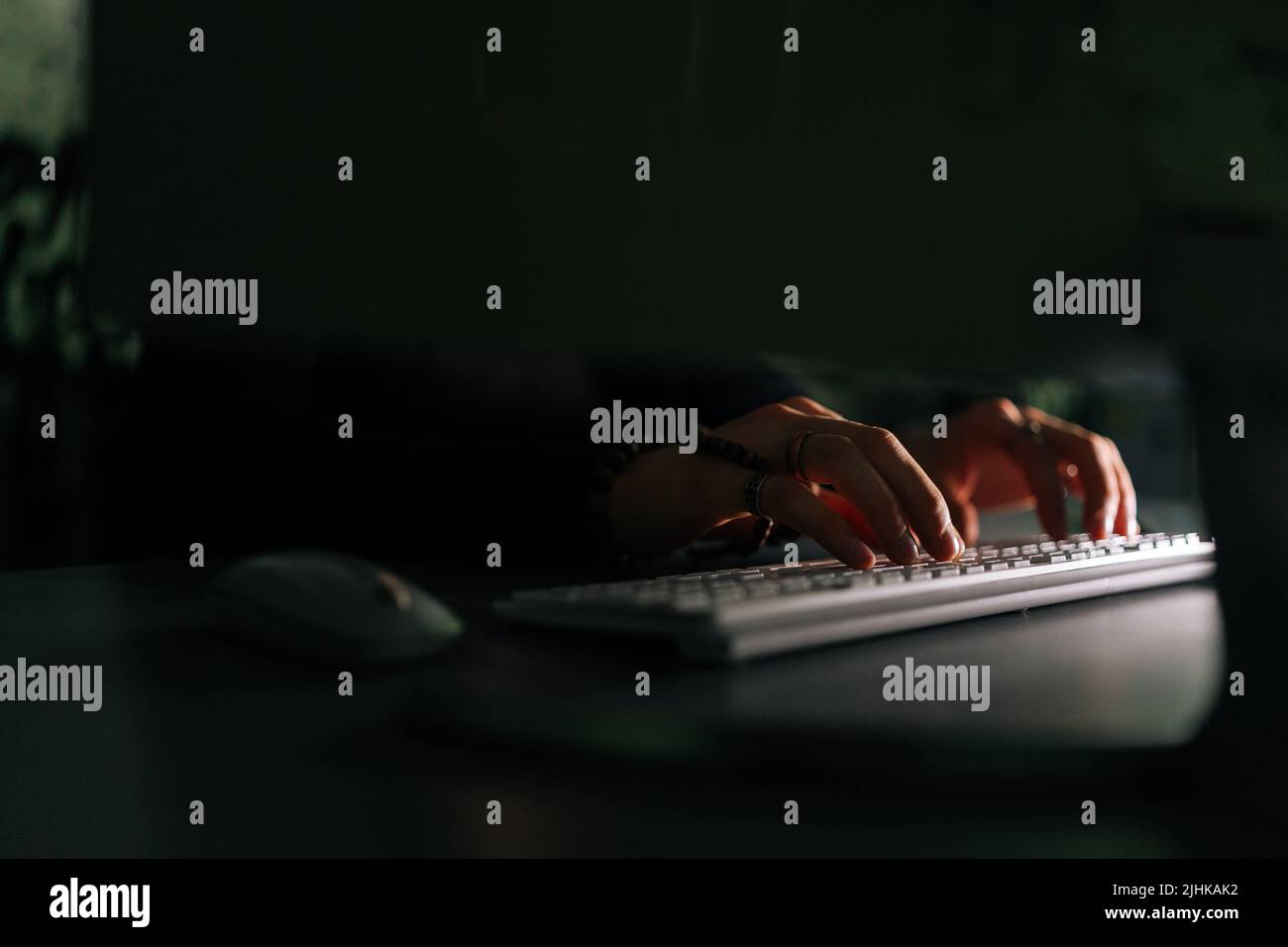 Close-up hands of unrecognizable hacker breaking online web site, engaging hacking into security ...