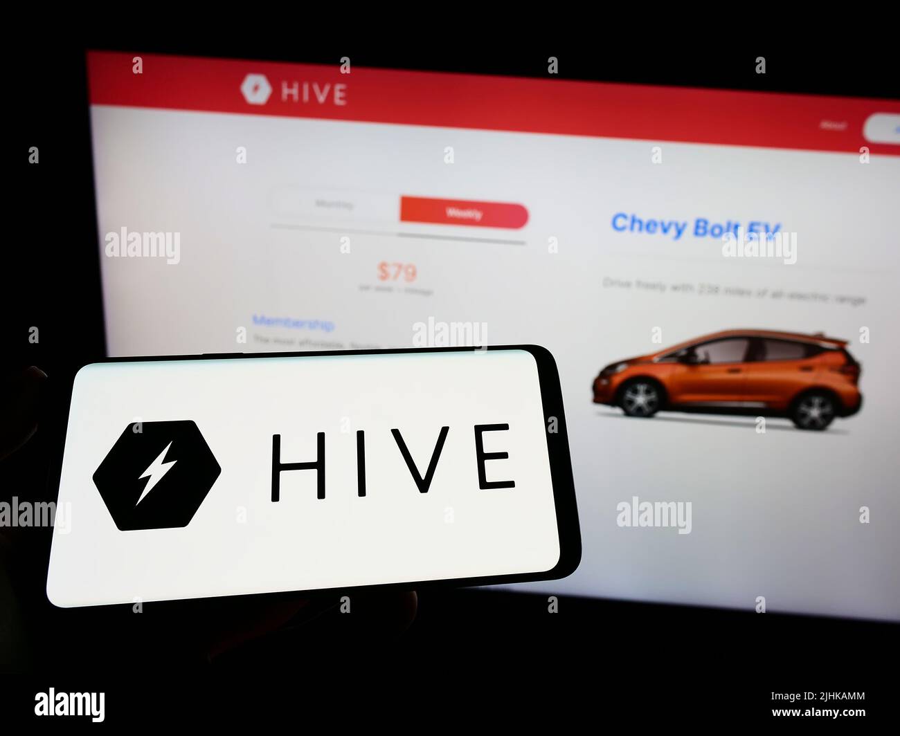 Person holding mobile phone with logo of US company Hive Technologies ...