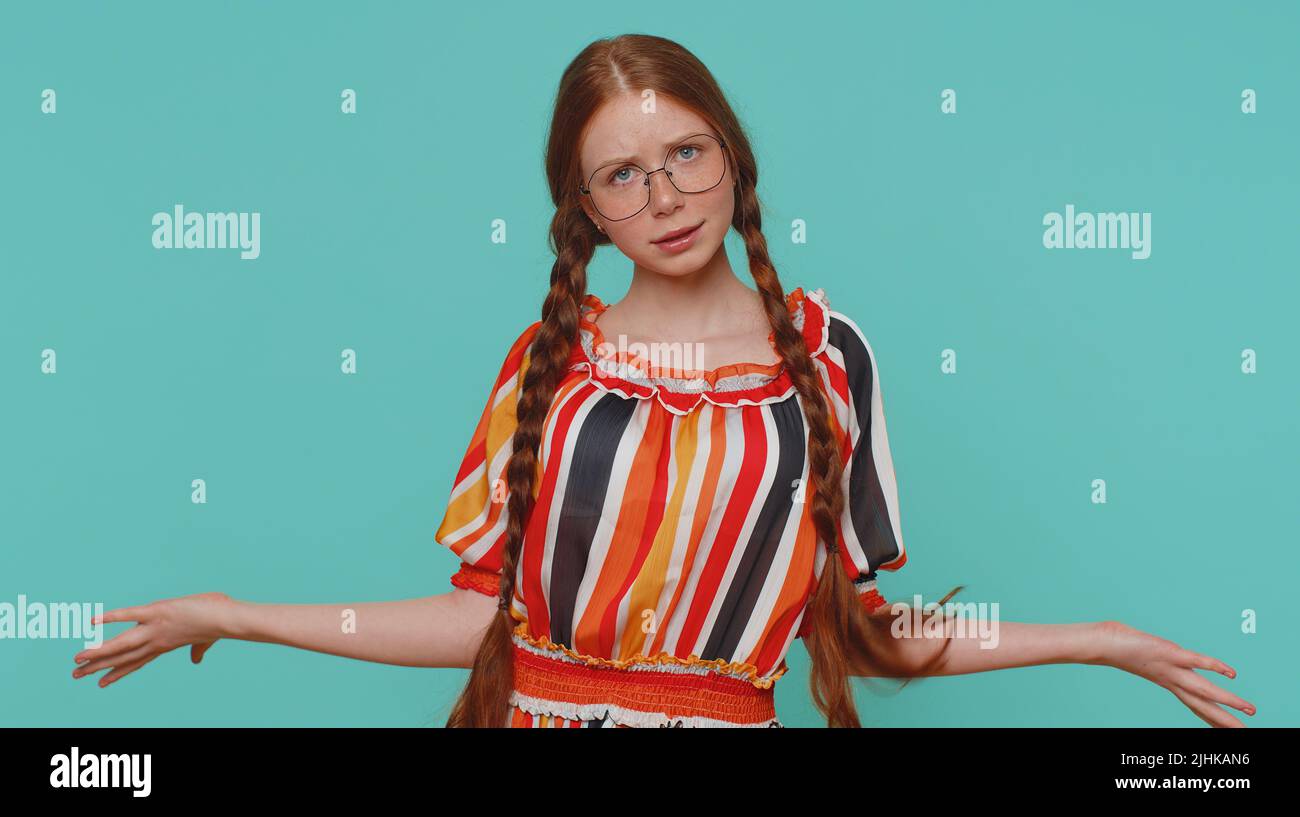 What Why. Sincere irritated redhead girl raising hands in indignant ...